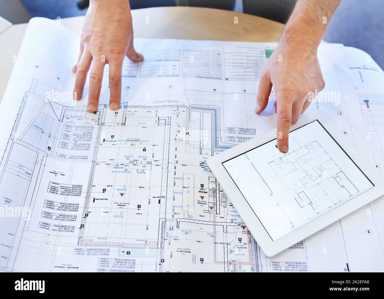 Going through the design with a fine-tooth comb. Shot of an architects ...