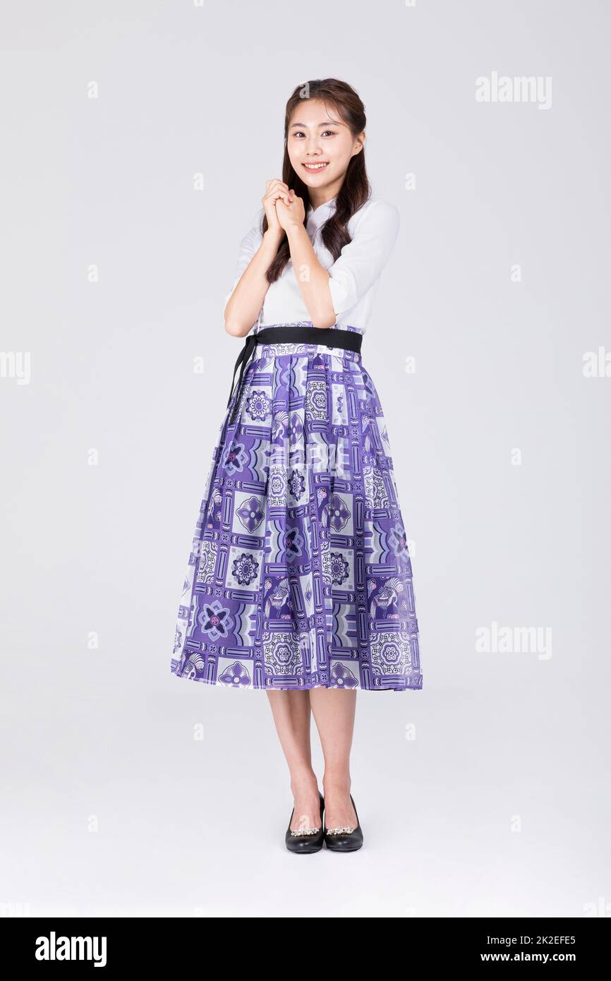 beautiful Korean woman in 20s wearing modern Hanbok wishing Stock Photo ...