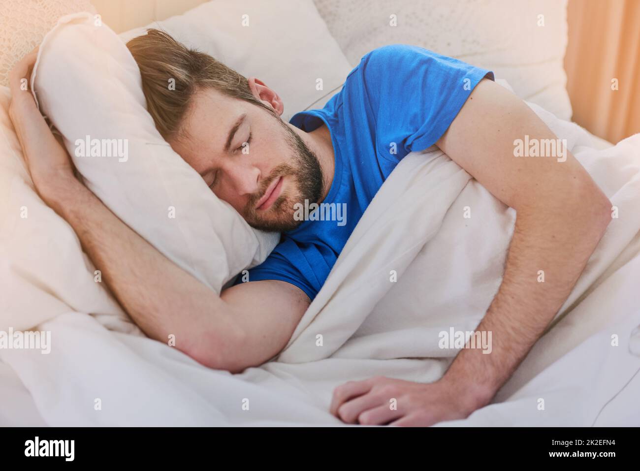 Handsome man sleeping in bed hi-res stock photography and images - Alamy