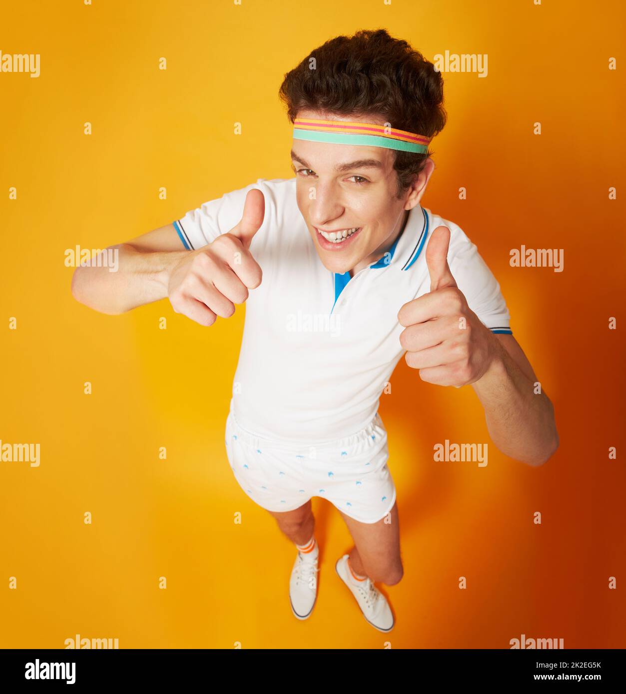 Thumbs up. A caucasian male holding his two thumbs up in manner of ...