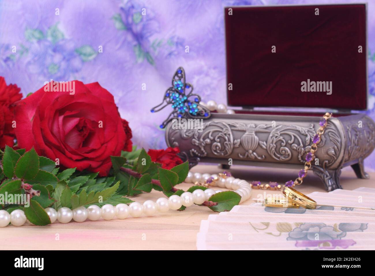 Red Roses with Wedding Bands and Jewelry Box Stock Photo - Alamy