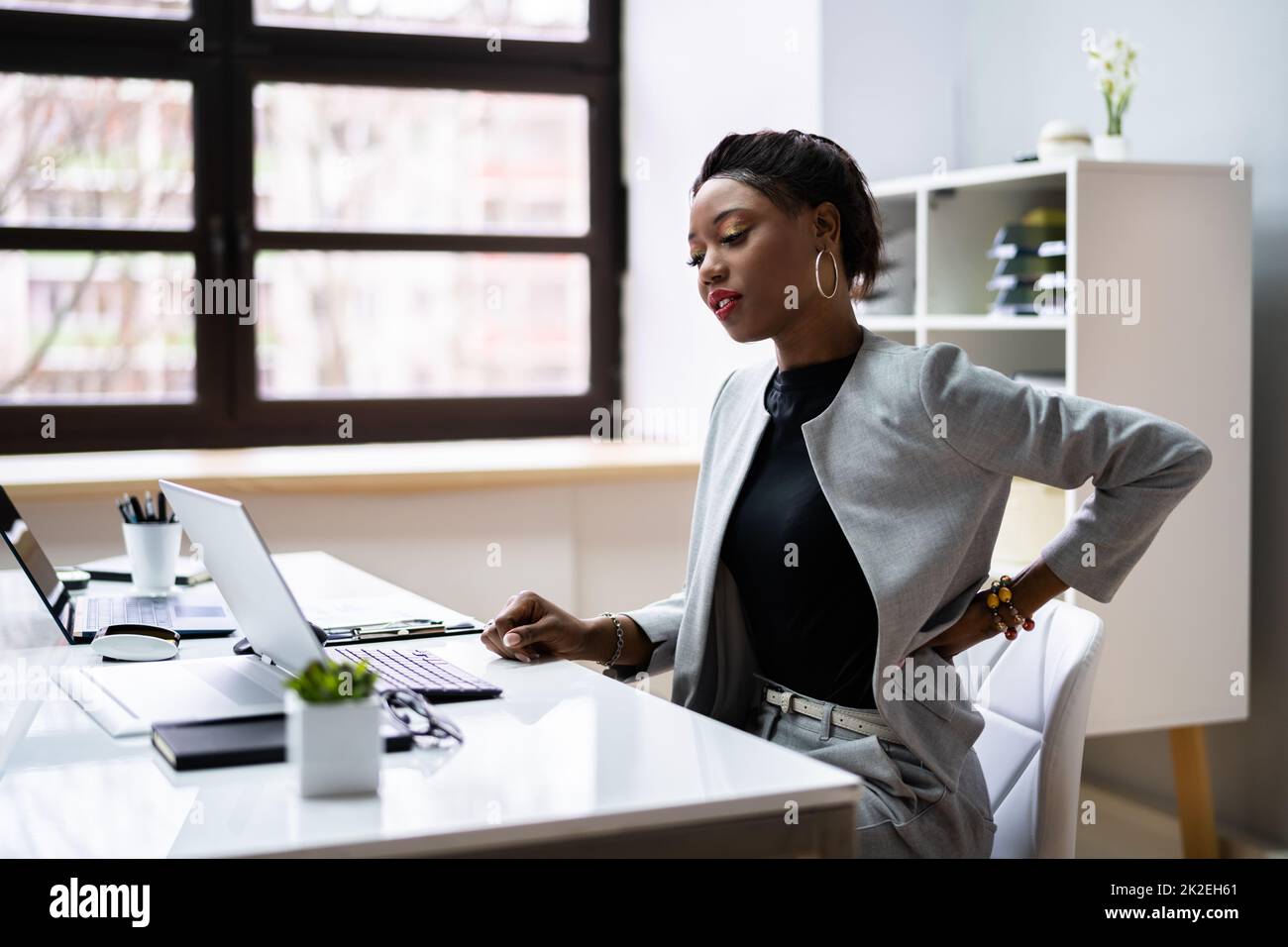 Back Pain Bad Posture Man Sitting Stock Photo - Alamy