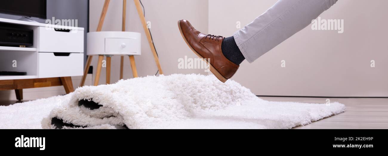 Man Legs Stumbling With A Carpet Stock Photo - Alamy