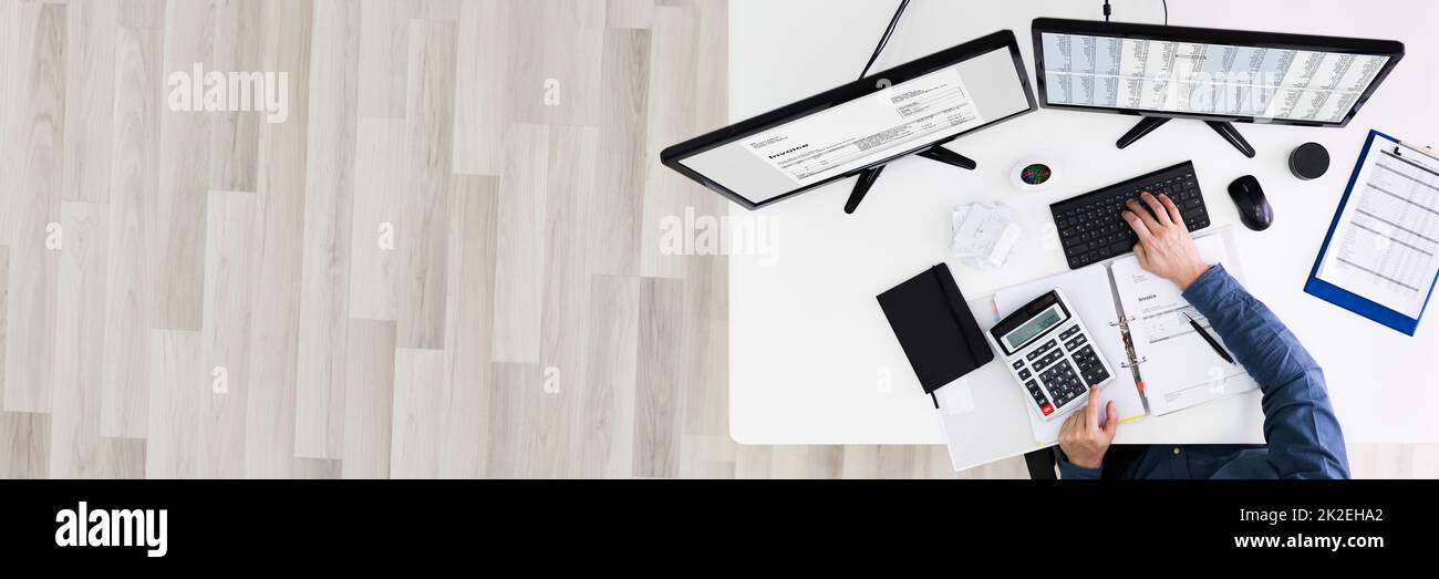 Young Businessman Calculating Bill In Office Stock Photo - Alamy