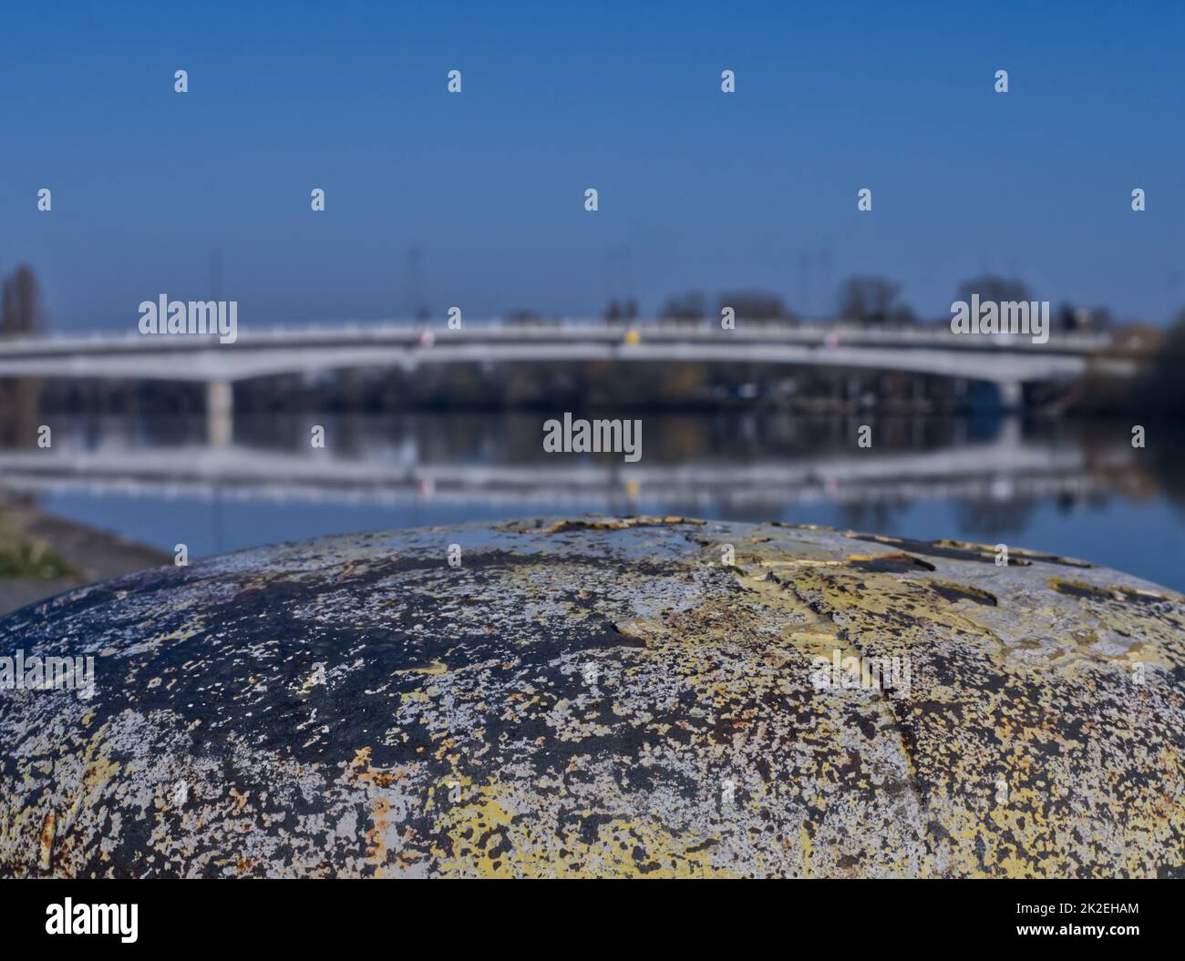 foreground: Closeup view top of a yellow rusty bollard, background ...