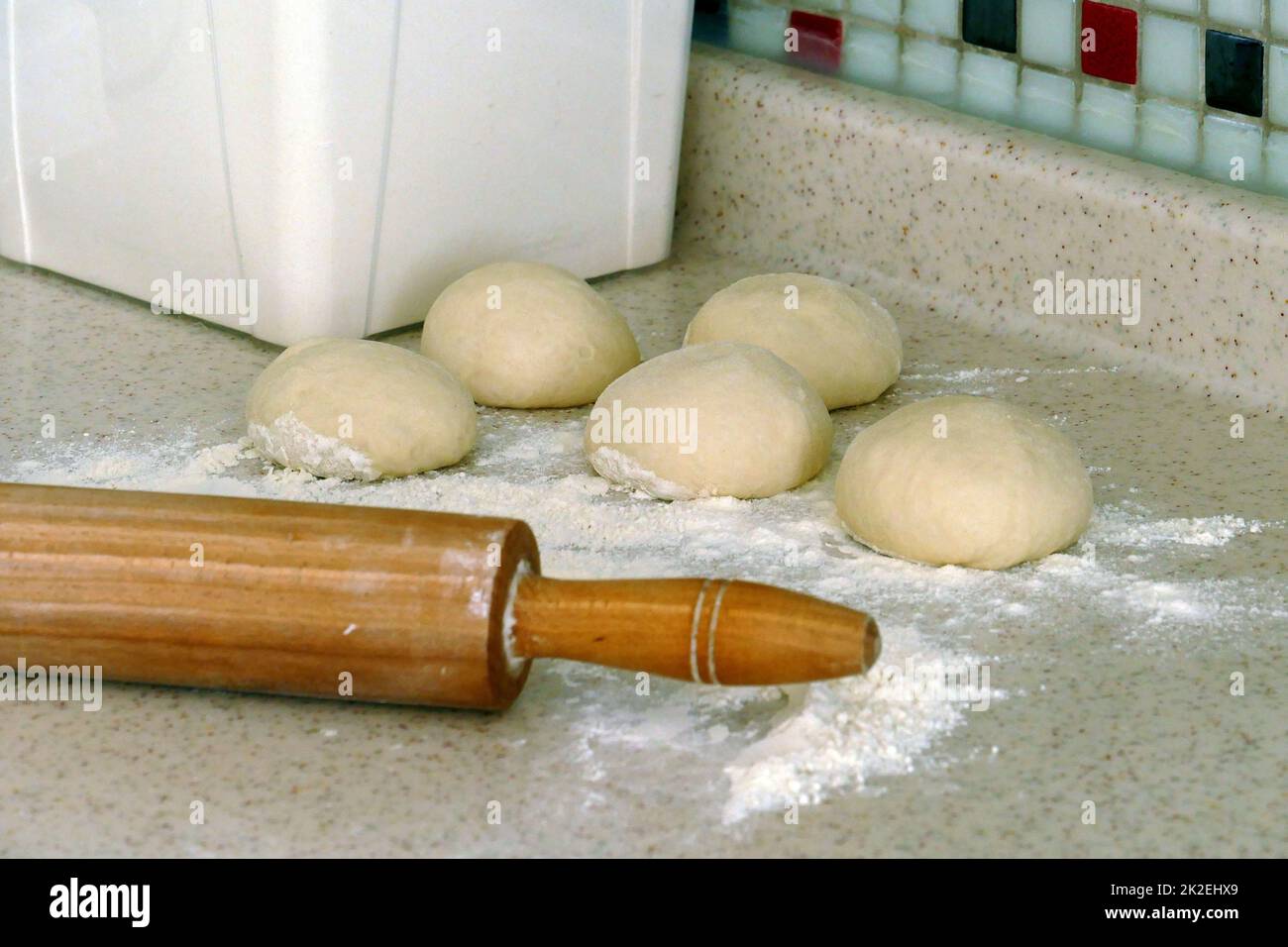 dough pieces, a person who rolls dough to make donuts Stock Photo - Alamy