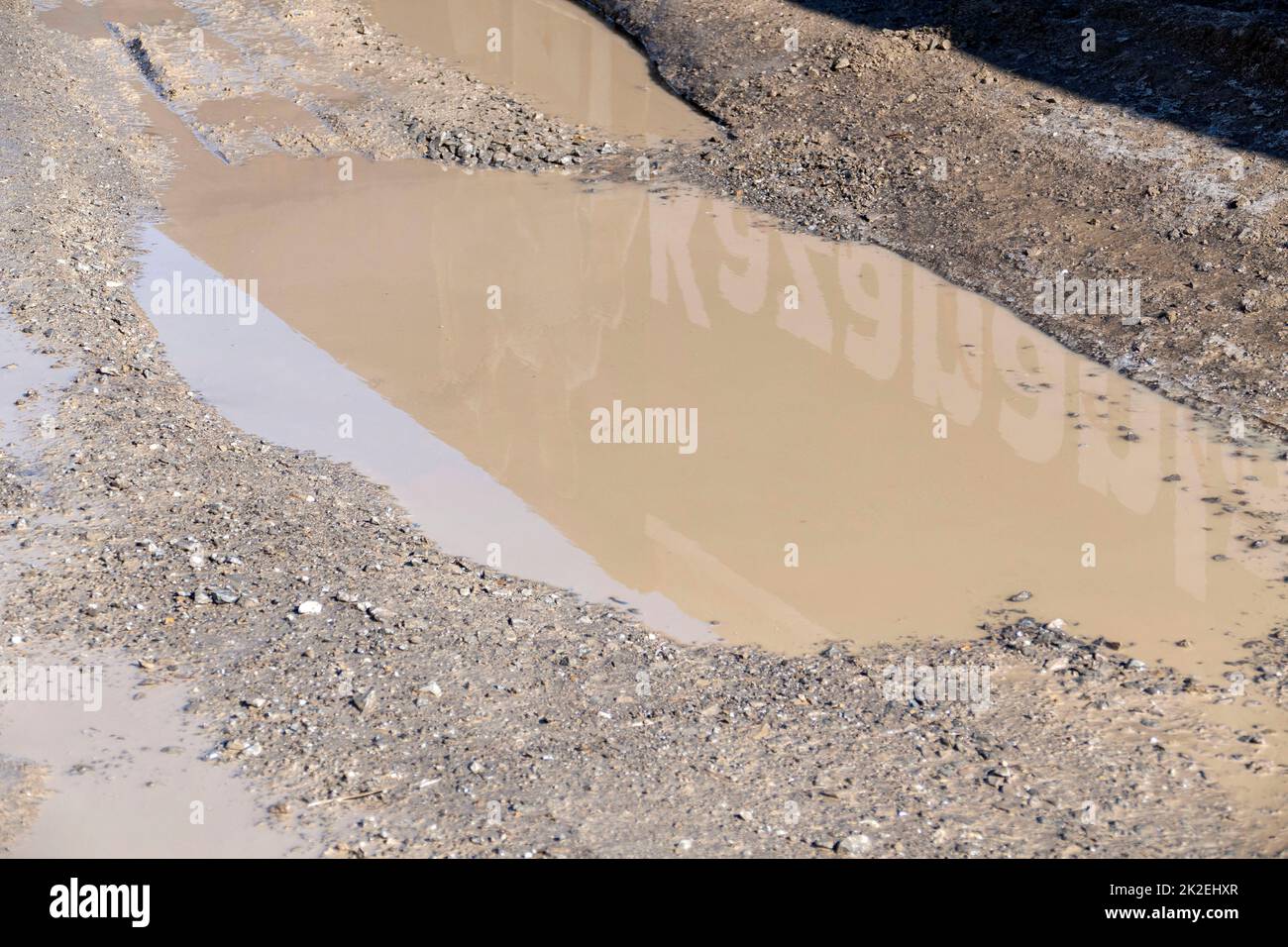 mud and dirty water puddle formed on the road after rain Stock Photo ...