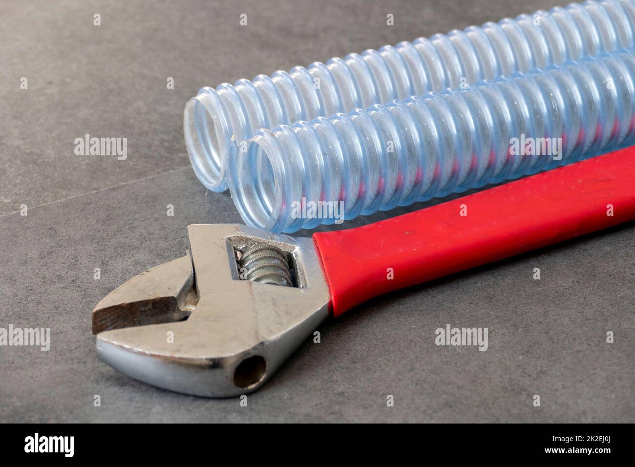 serrated kitchen drain pipe and wrench Stock Photo - Alamy