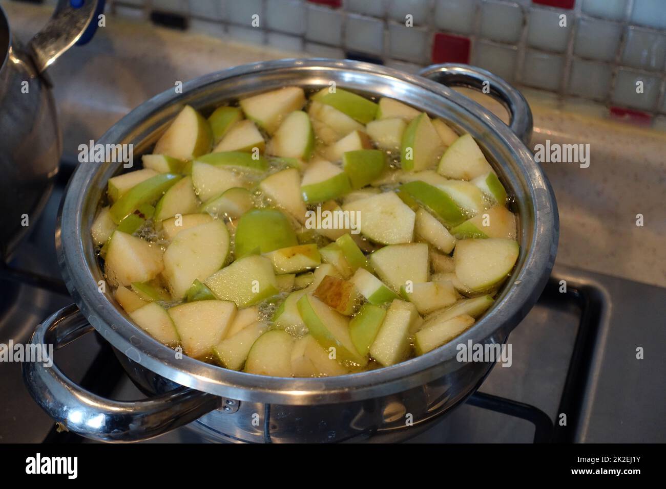 making apple compote,chopped apple pieces boiling in a pot,making ...