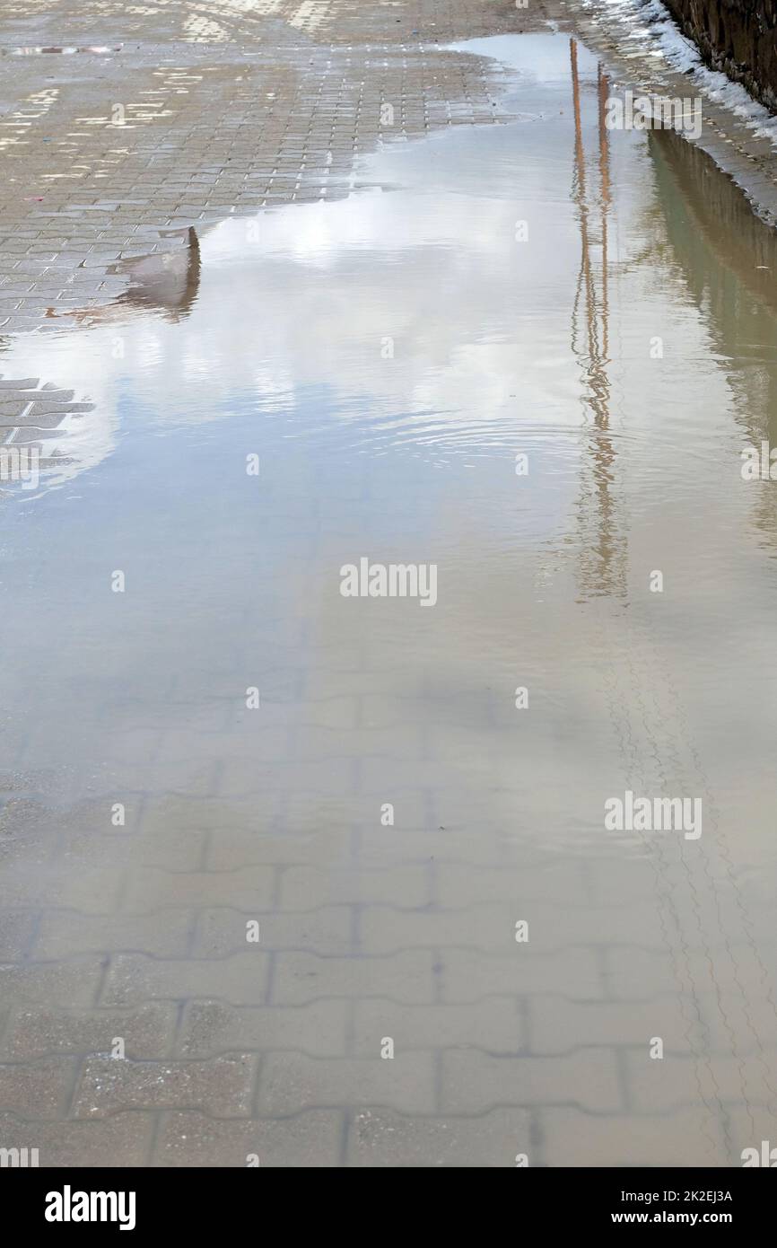 puddles of rain and mud accumulating on city streets Stock Photo - Alamy