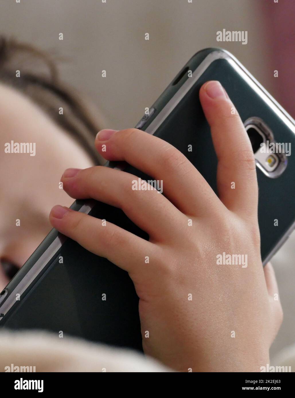 A 4-5 year old child is playing with a smart mobile phone, mobile phone ...