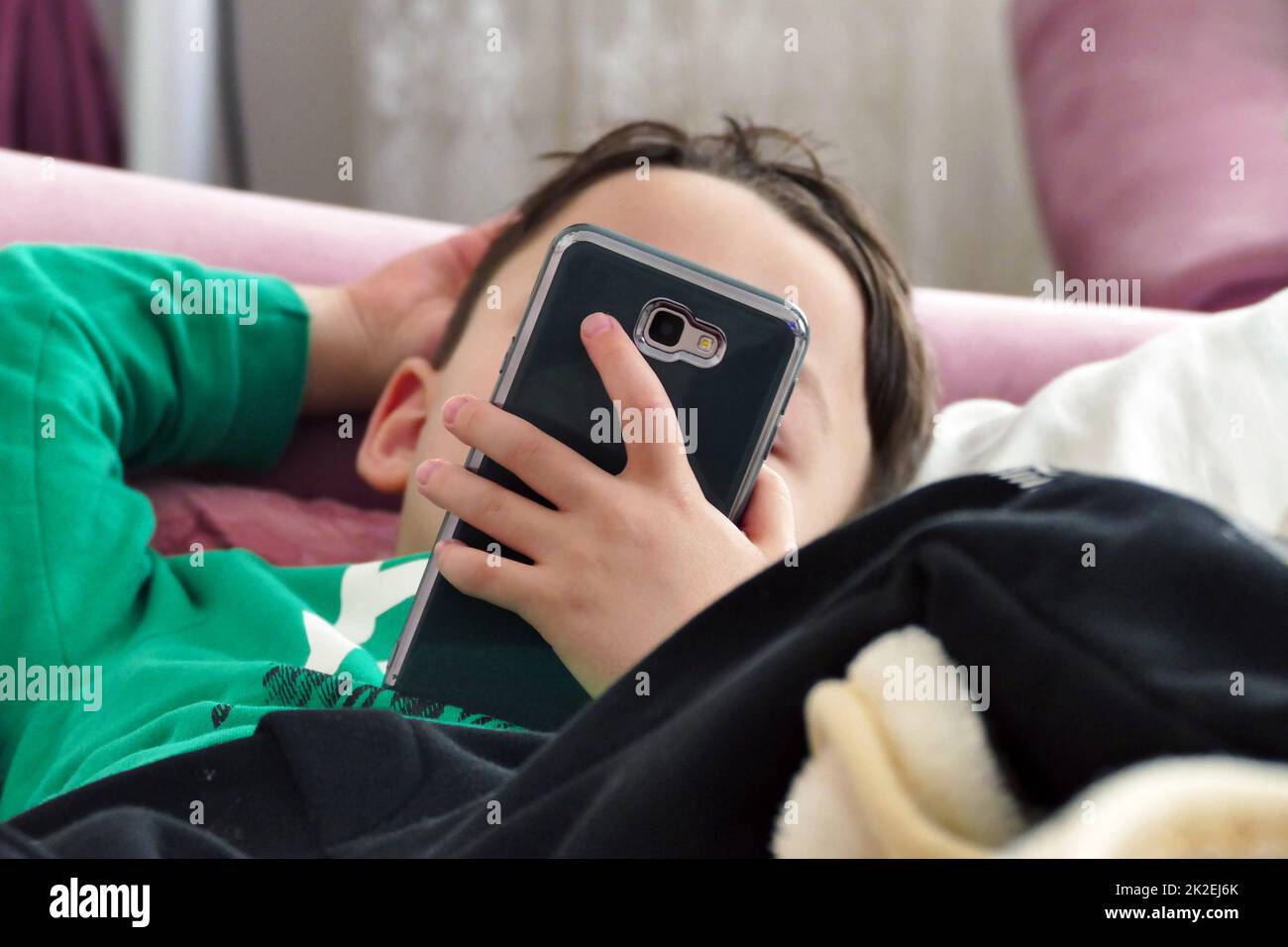 A 4-5 year old child is playing with a smart mobile phone, mobile phone ...