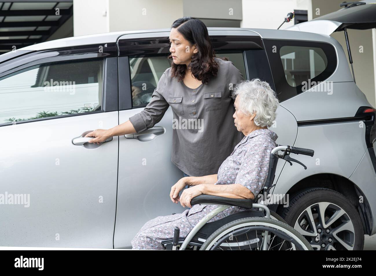 Help and support asian senior or elderly old lady woman patient prepare ...