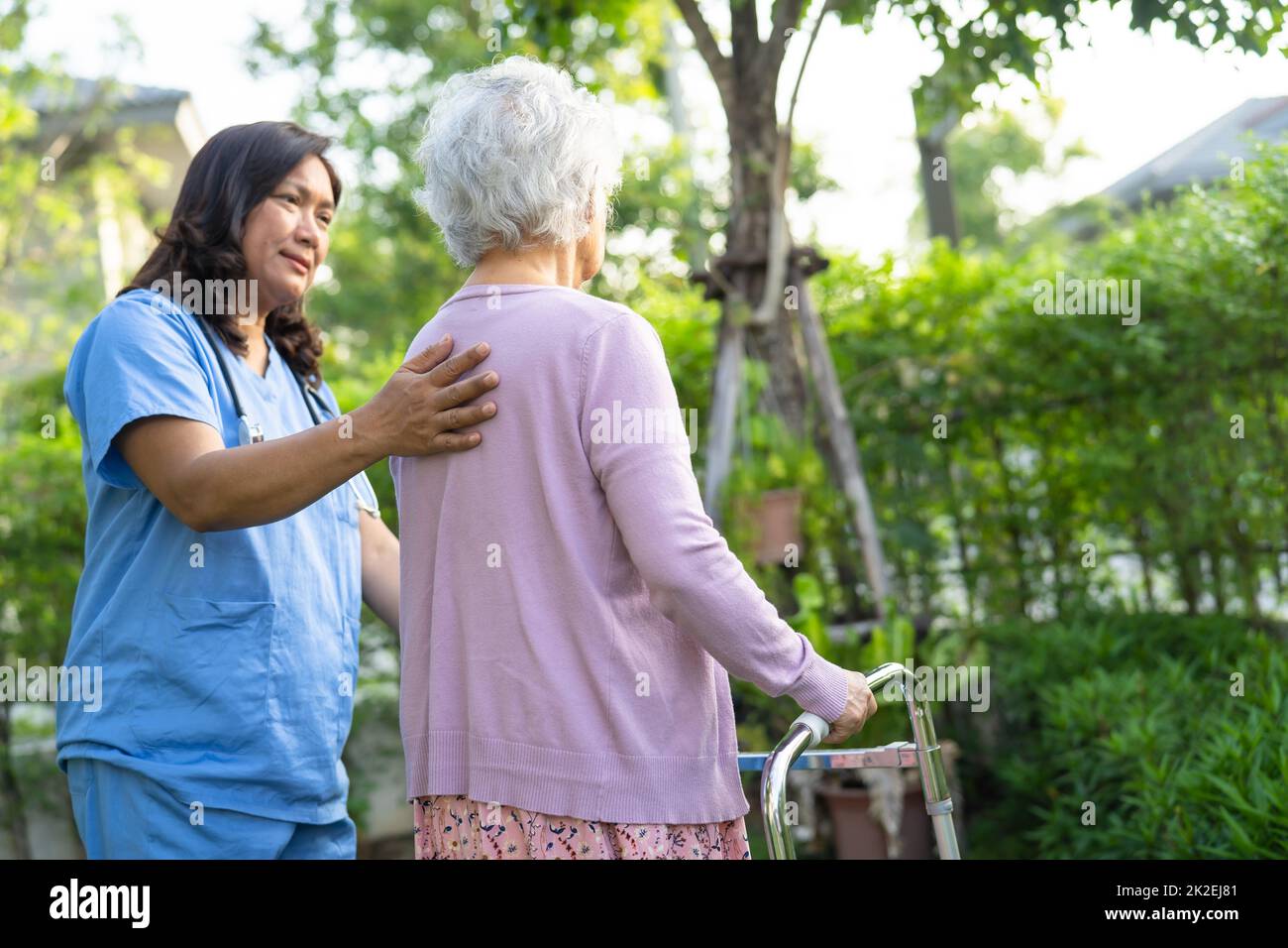 Doctor help and care Asian senior or elderly old lady woman use walker ...