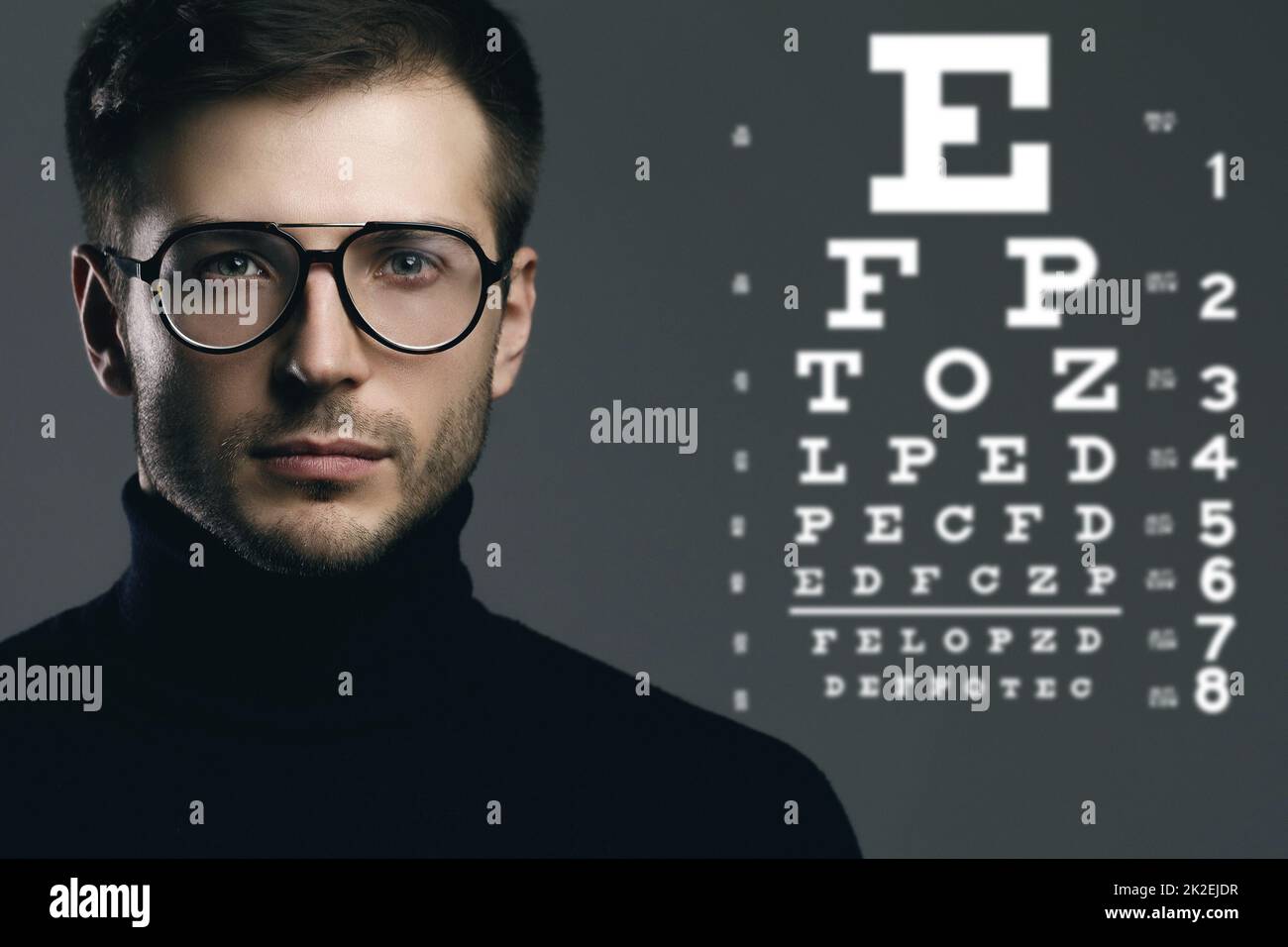Handsome man wearing eyeglasses and eye chart Stock Photo - Alamy