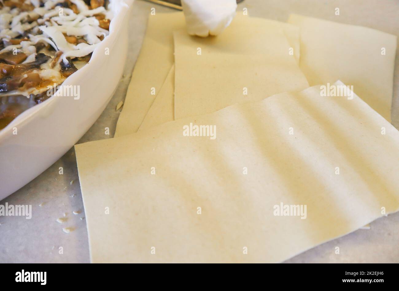 Cooking traditional homemade lasagna. Lasagna sheets NEAR A ROUND ...
