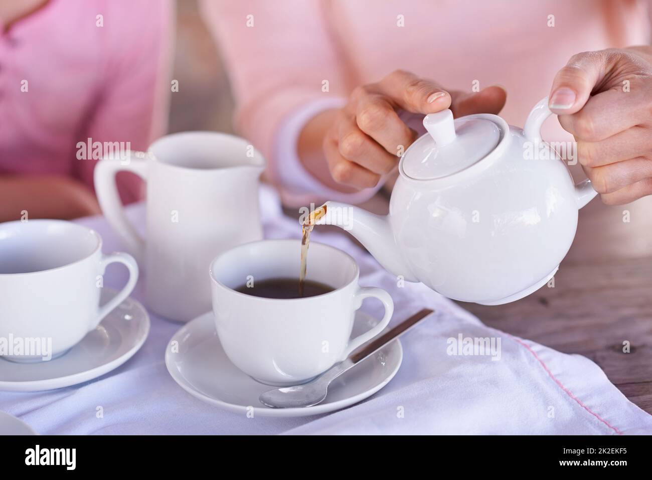 Mom pouring tea outdoors hi-res stock photography and images - Alamy