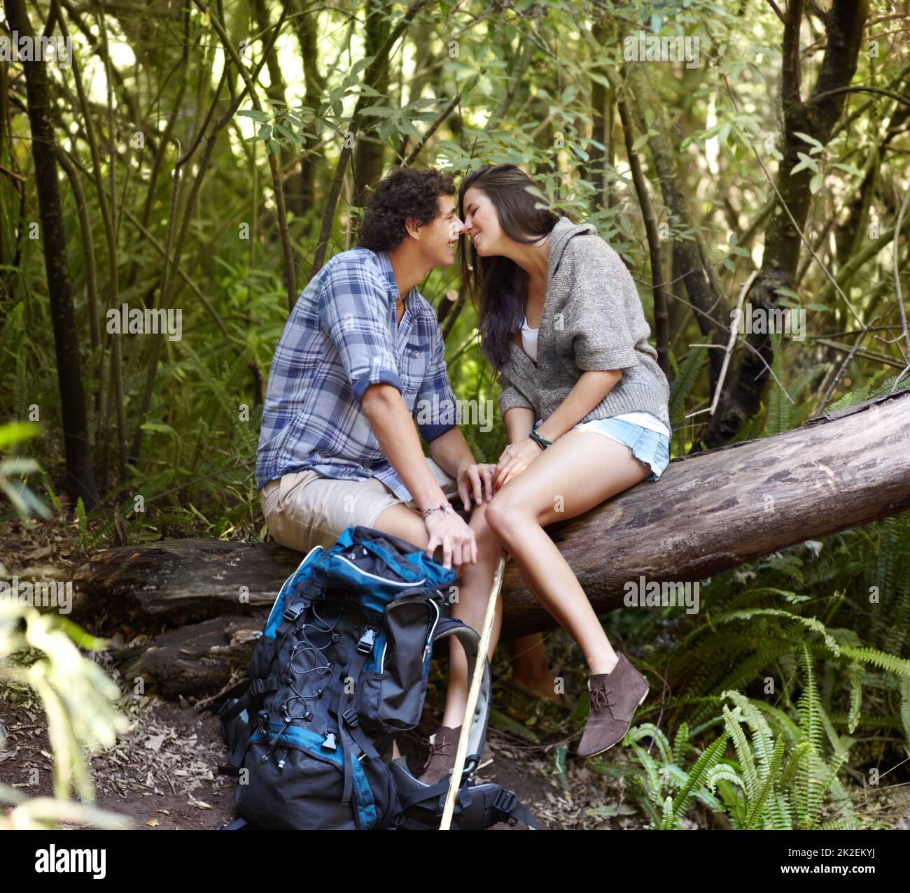 Enjoying a romantic hideaway. A happy young couple kissing while ...