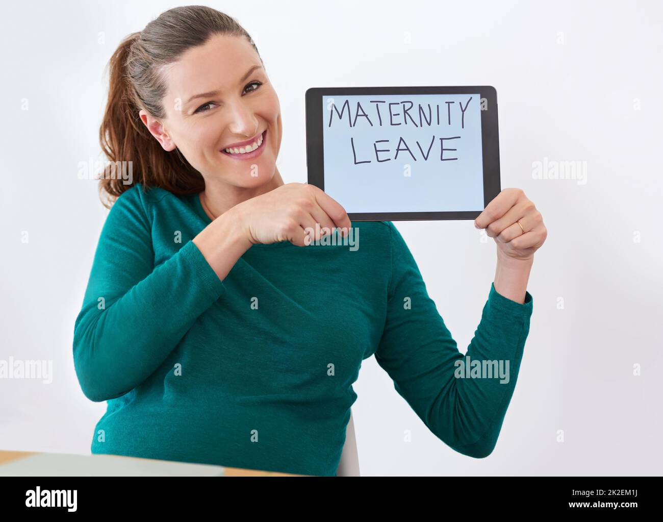 Shes expecting her baby soon. Shot of a pregnant woman holding up a ...