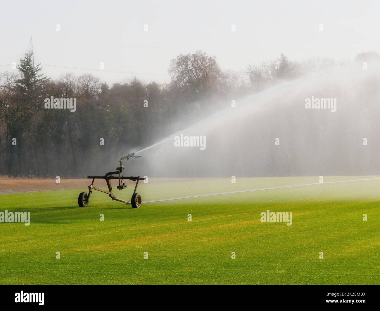 Watering field with irrigation system Stock Photo - Alamy