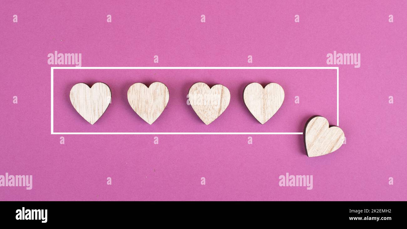 Five hearts on a colored background, hand put the last heart in the row ...