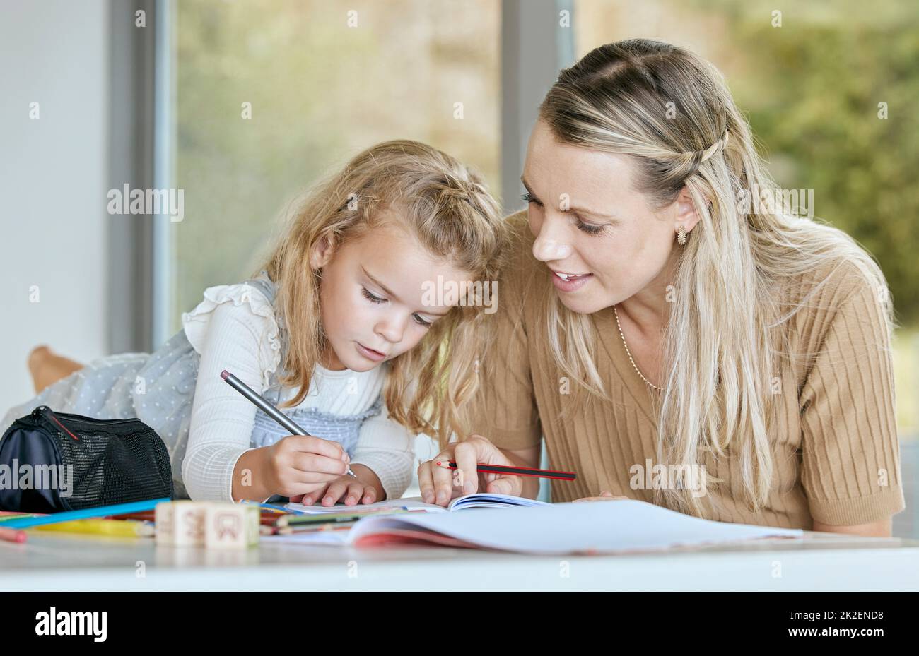 Mother help youth girl with school work, homework or preschool ...