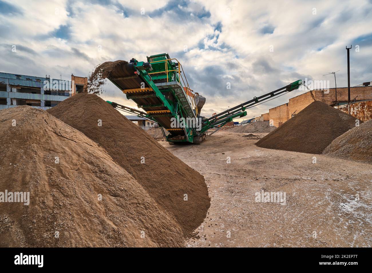 Mobile crushing and sorting complex works among soil piles Stock Photo ...