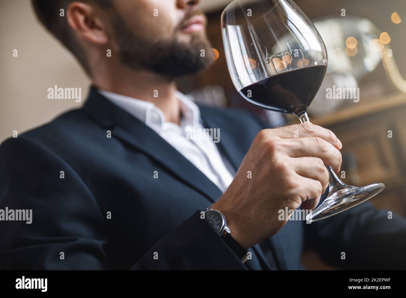 Man with a glass of red wine Stock Photo - Alamy