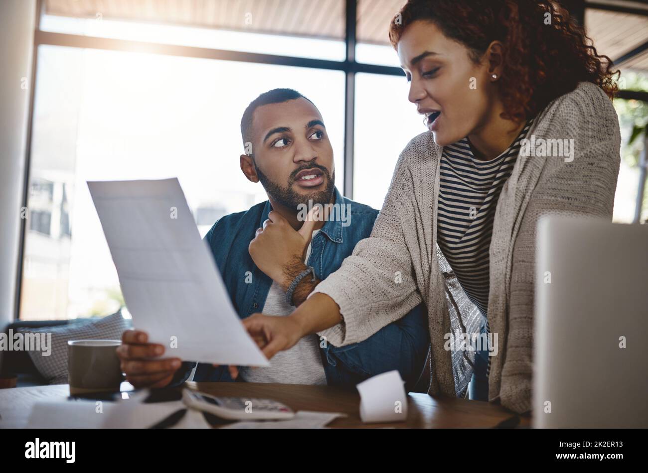 Ensure you delve into your budget with a solid plan. Shot of a young ...