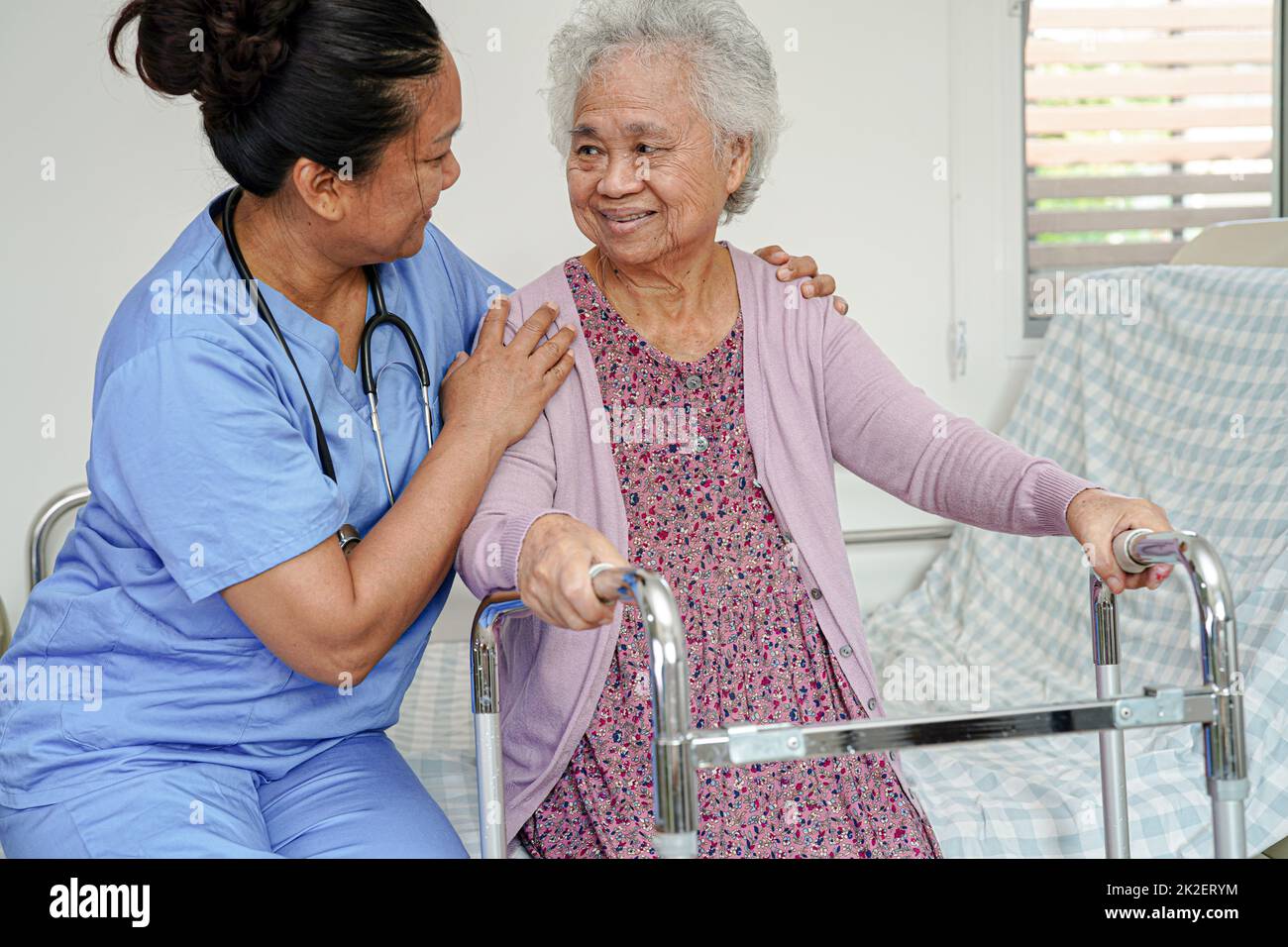 Doctor help Asian elderly woman disability patient walk with walker in ...