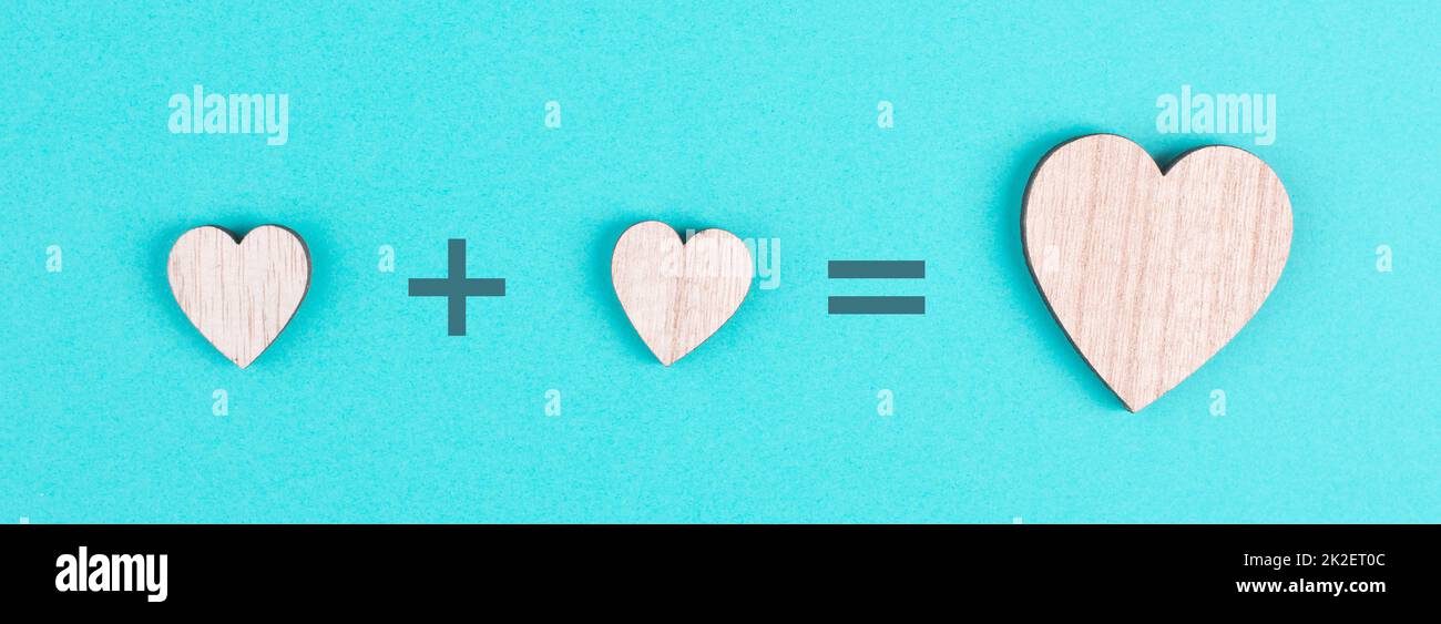 Addition of two little hearts becoming a big one, symbol for love and ...