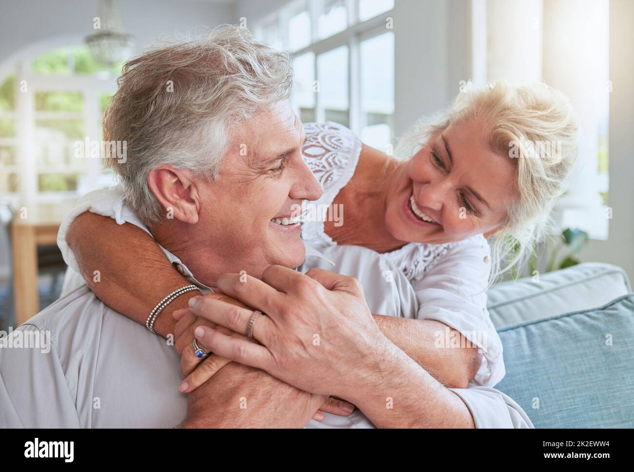 Senior couple sharing a hug Stock Photo - Alamy