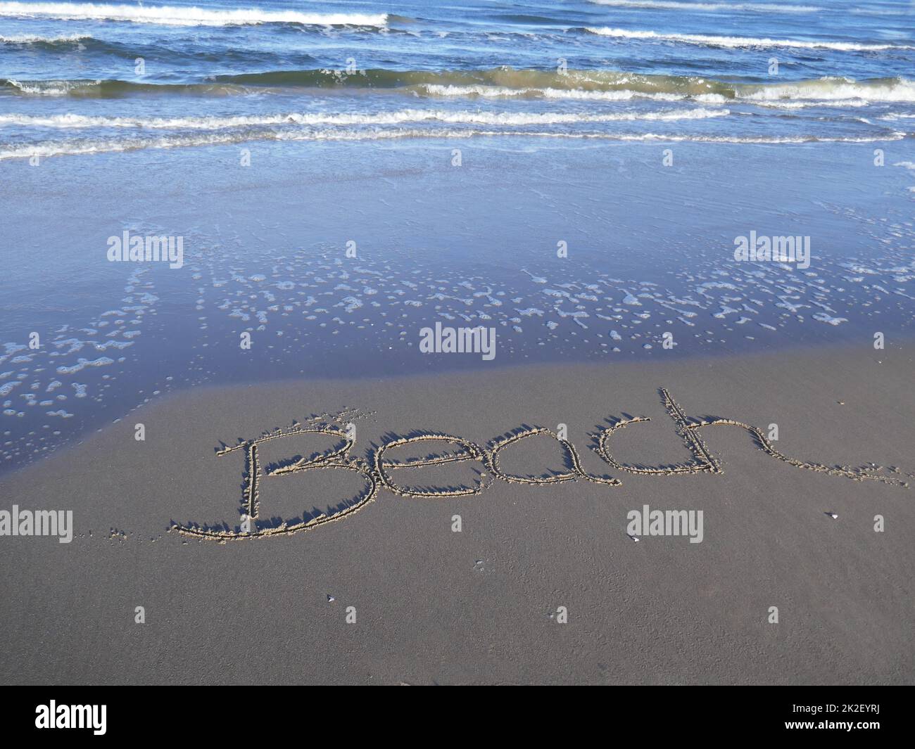 Beach written in the sand Stock Photo - Alamy