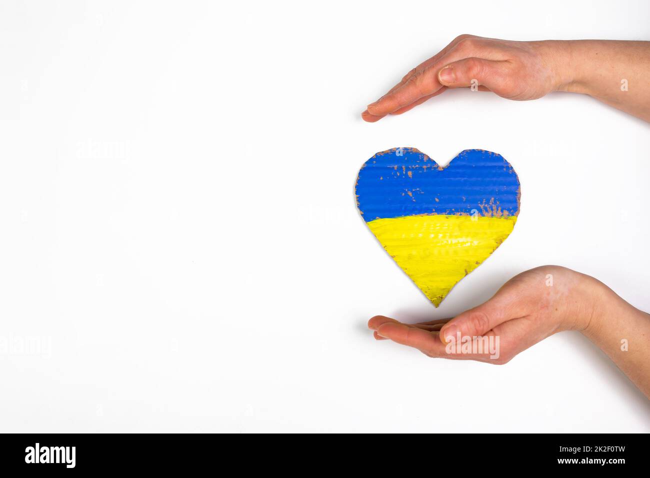 Heart flag of Ukraine in human hands. No war, peace for Ukraine concept ...