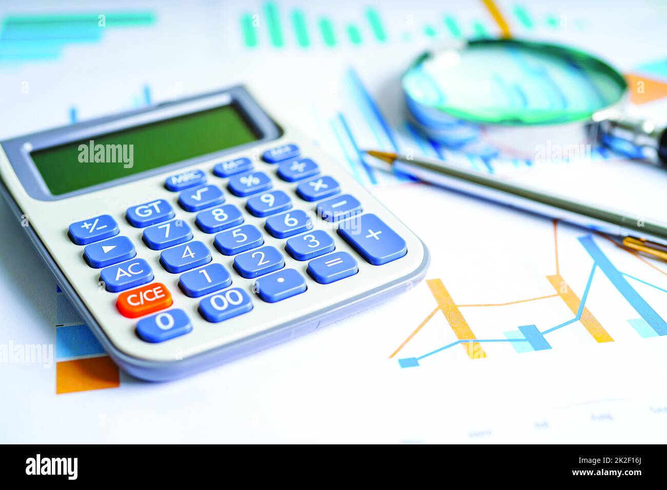 Calculator on chart and graph spreadsheet paper. Finance development ...