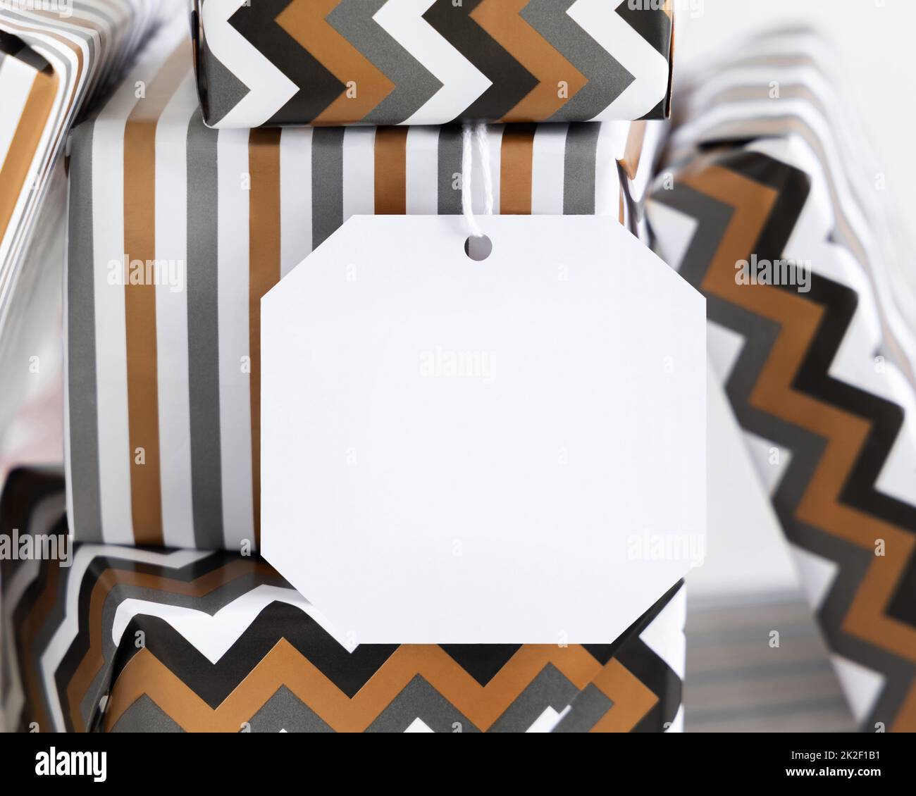 Wrapped present with blank gift tag close up, label Mockup Stock Photo ...