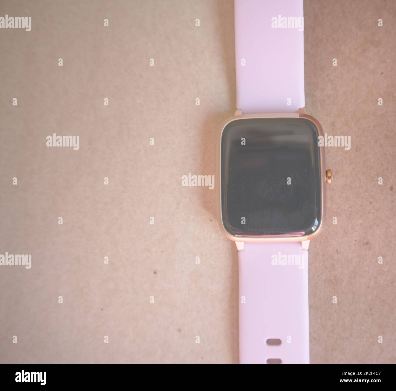 Wireless Smart Watch with Pink Strap Isolated on Brown kraft Paper ...