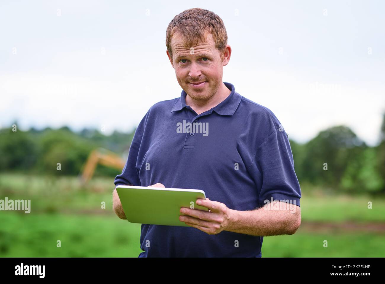 Making farming easier with modern tech. Shot of a farmer using a ...