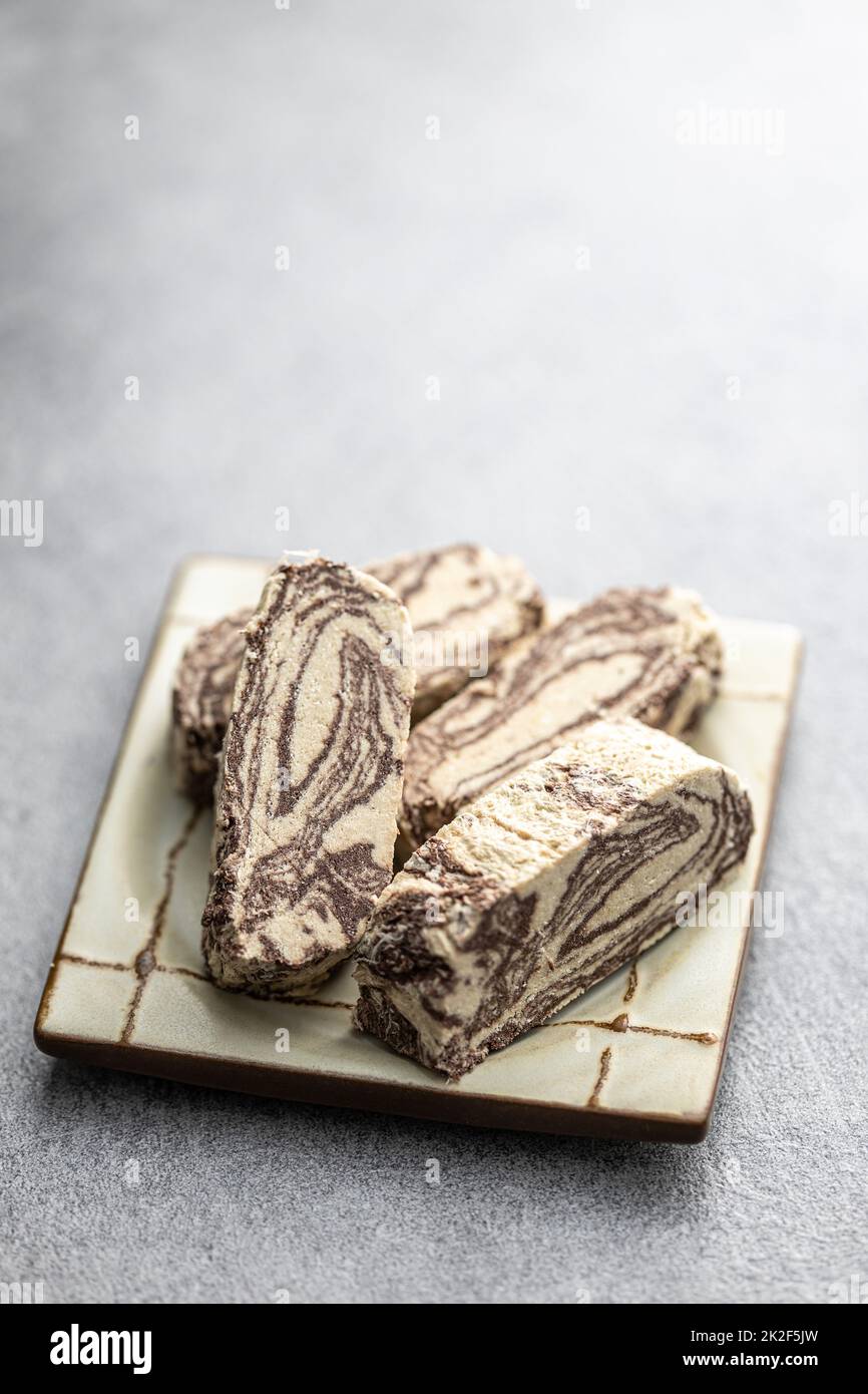 Sweet tahini halva with cocoa flavor. Turkish dessert on plate Stock ...