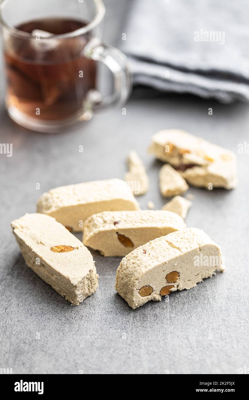 Sweet tahini halva with almonds. Turkish dessert gray table Stock Photo ...