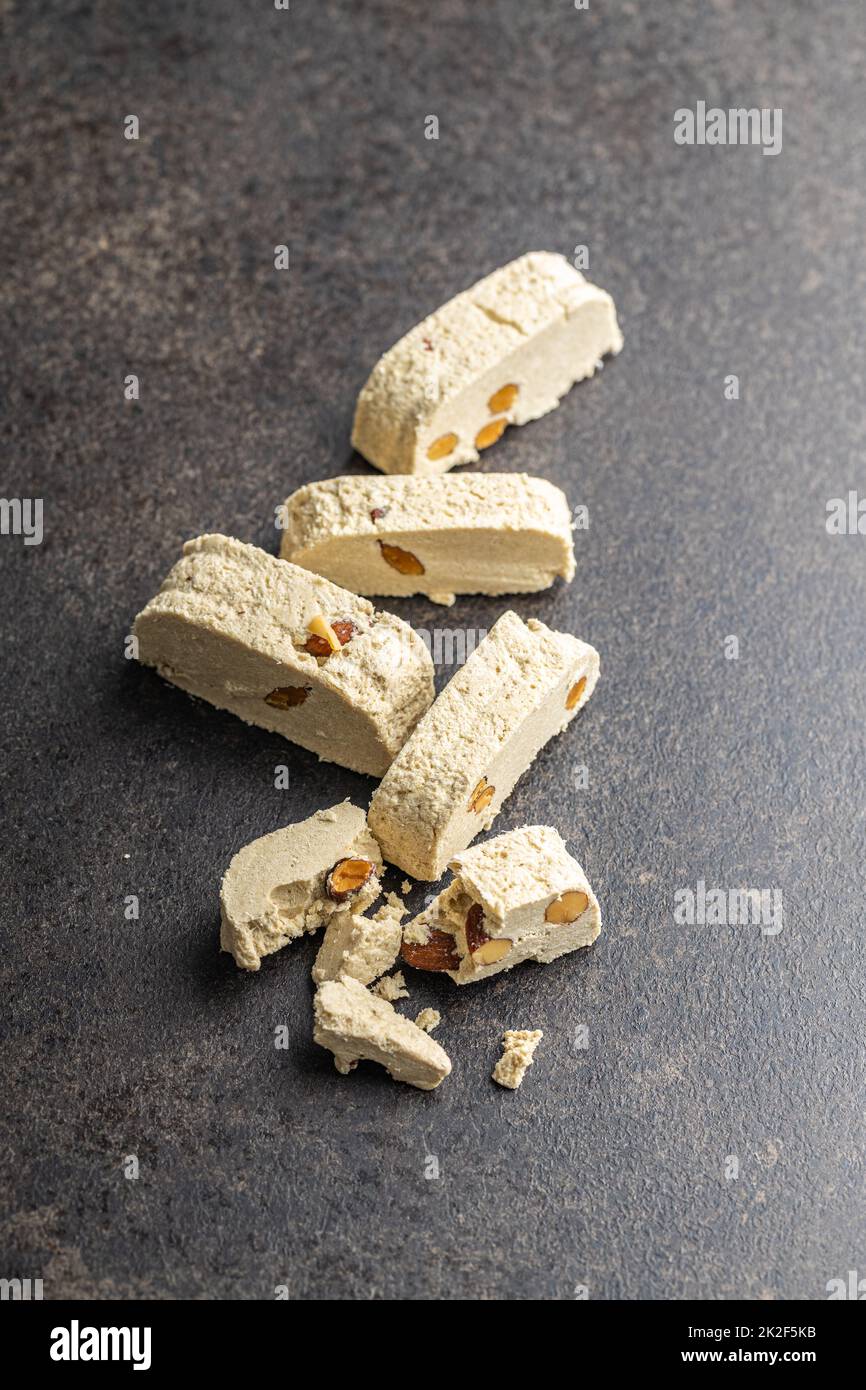 Sweet tahini halva with almonds. Turkish dessert on kitchen table Stock ...