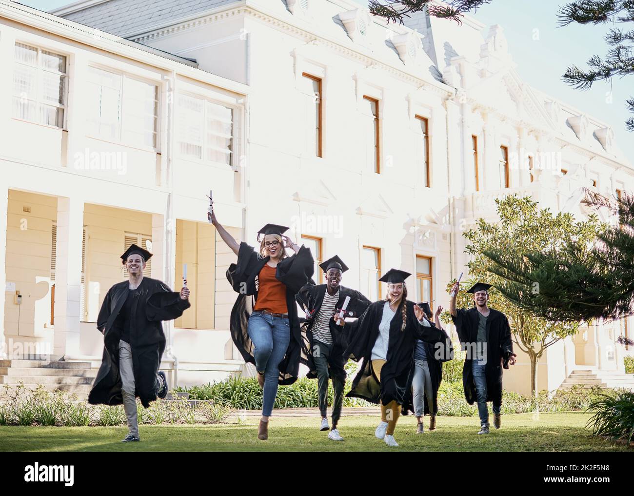 Running straight towards their dreams. Shot of a group of students ...