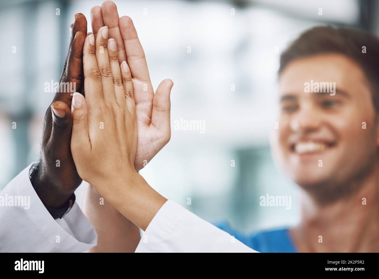 Hands, high five and collaboration with a team of a doctor, nurse and ...