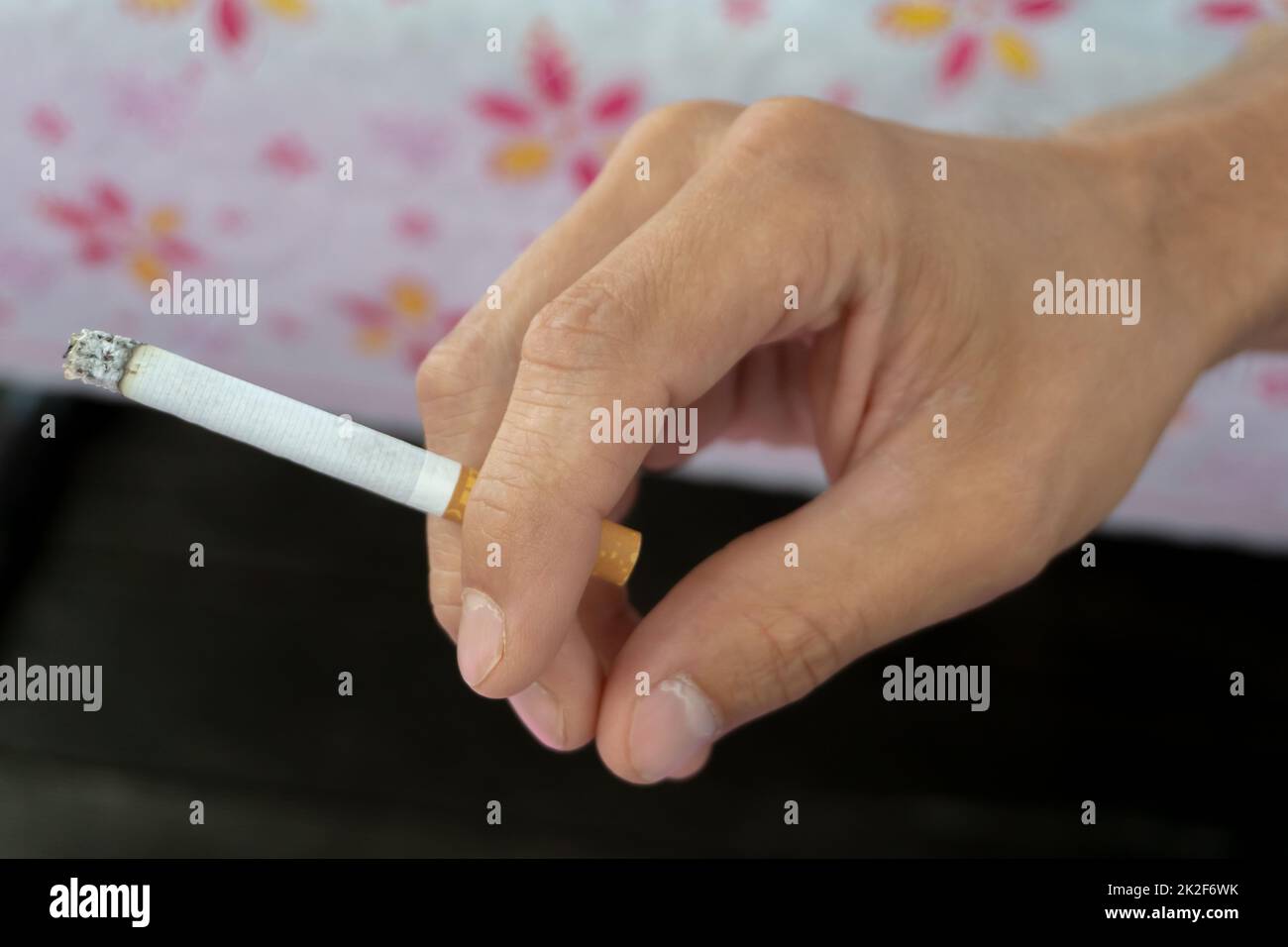 Burning Cigarette In Hand