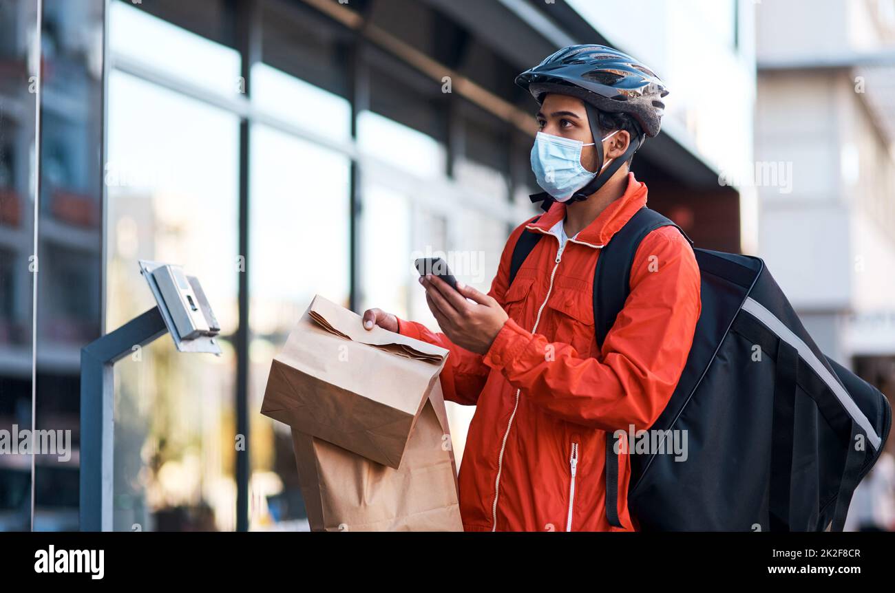 The app brought me to this address. Shot of a masked man using his ...