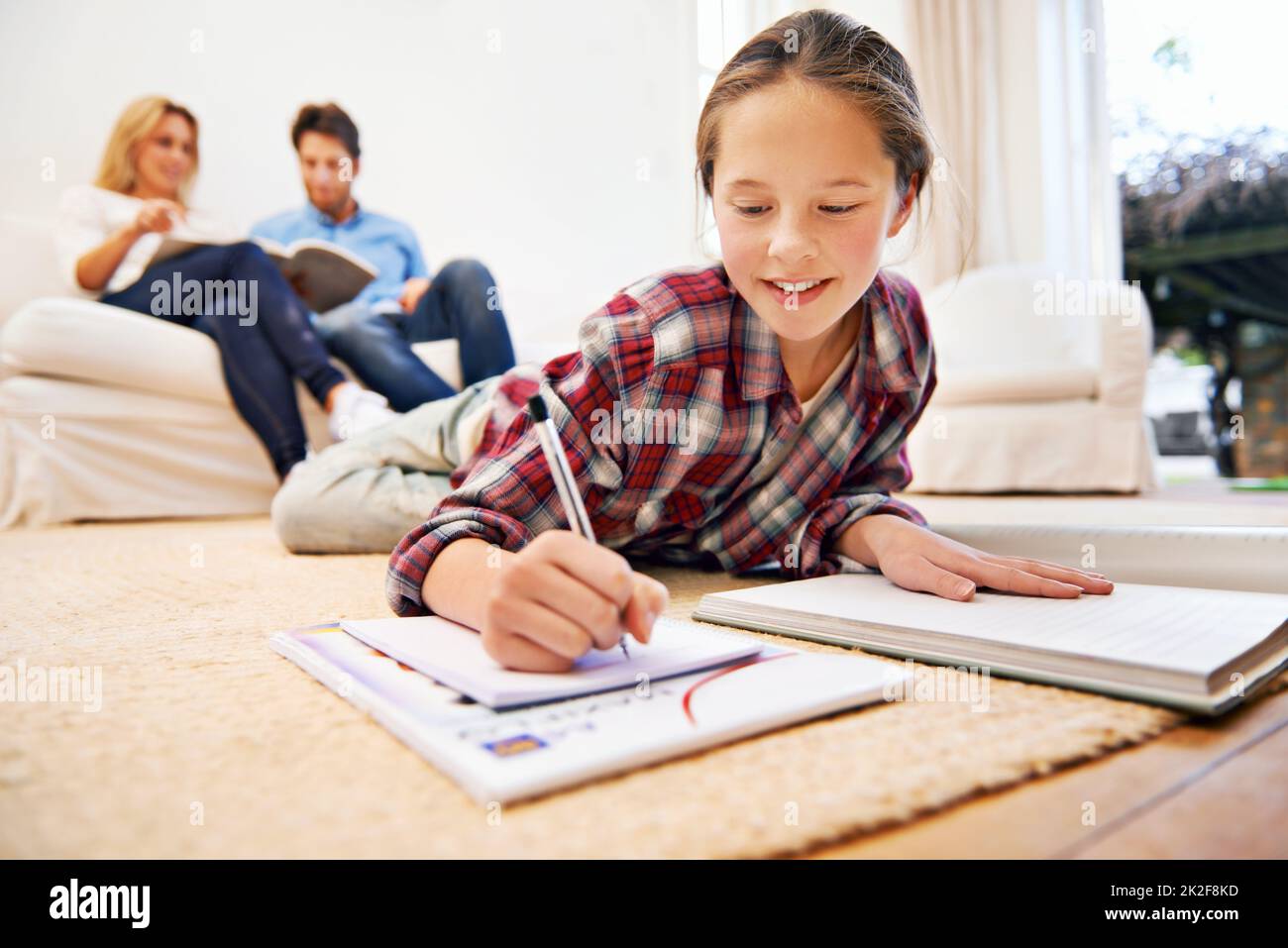 Kids doing homework lying on hi-res stock photography and images - Alamy