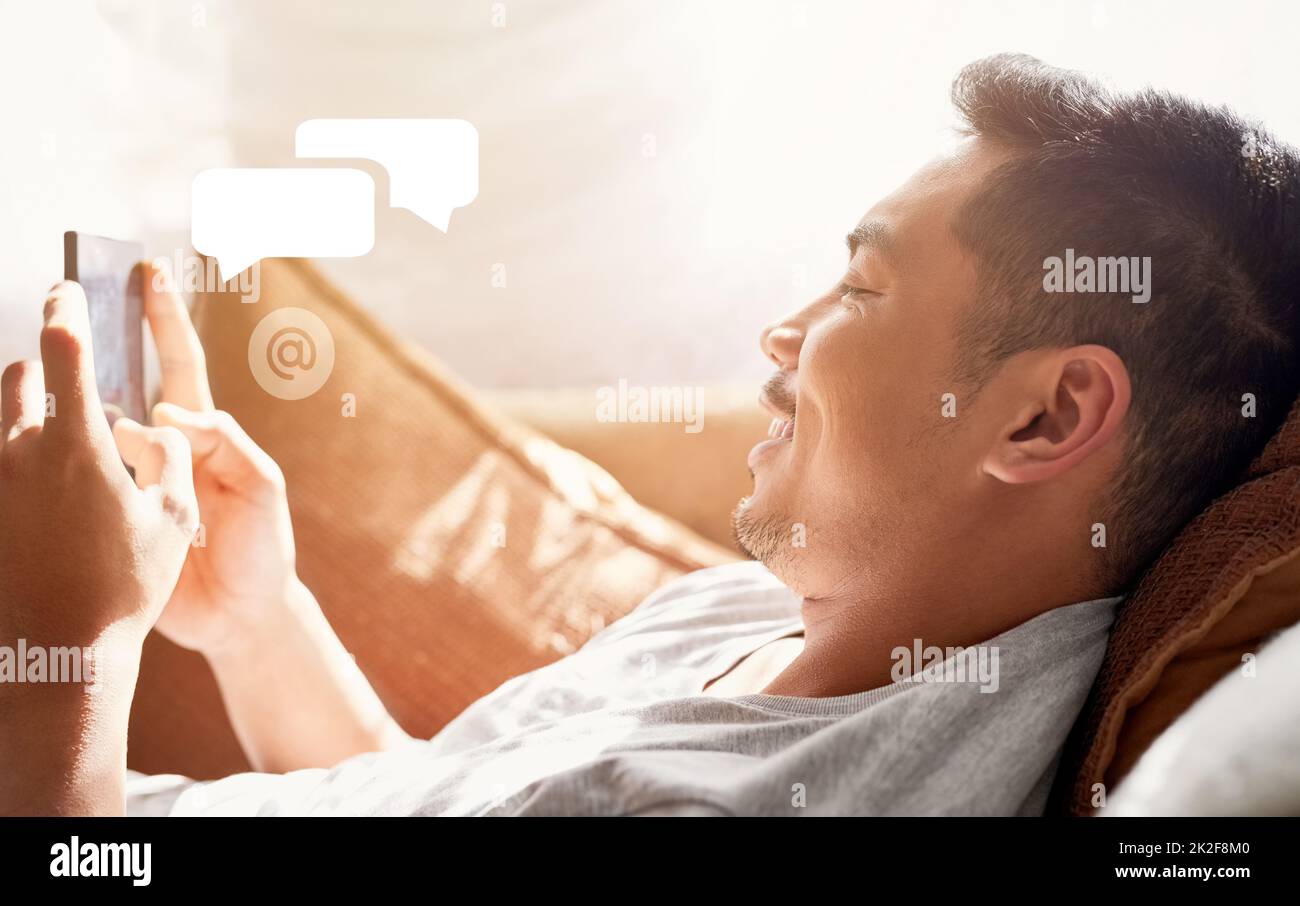 The easiest way to stay in touch with his friends. Shot of a happy ...