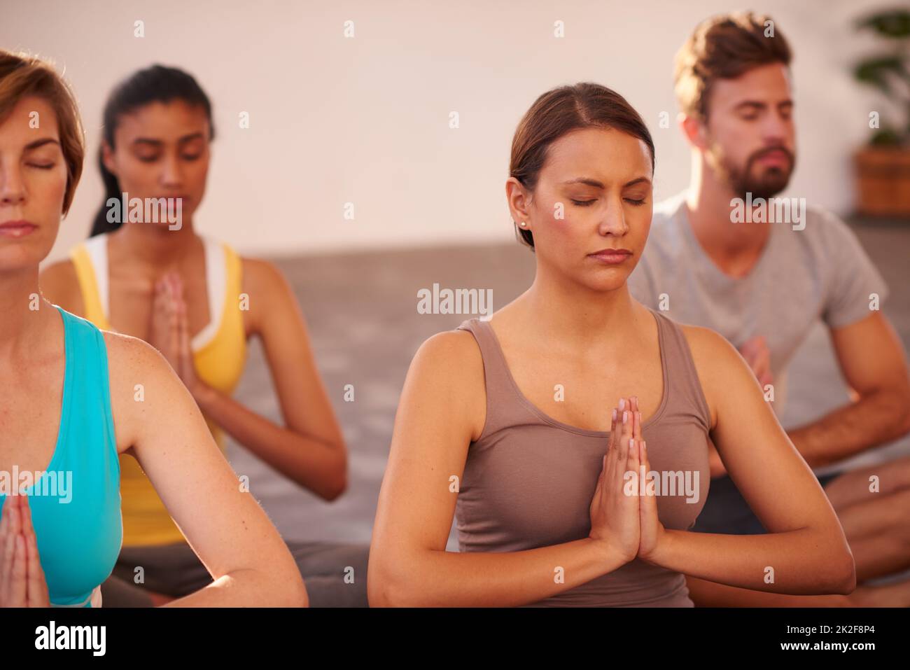 Meditation is the key to energy. A group of people doing yoga together ...