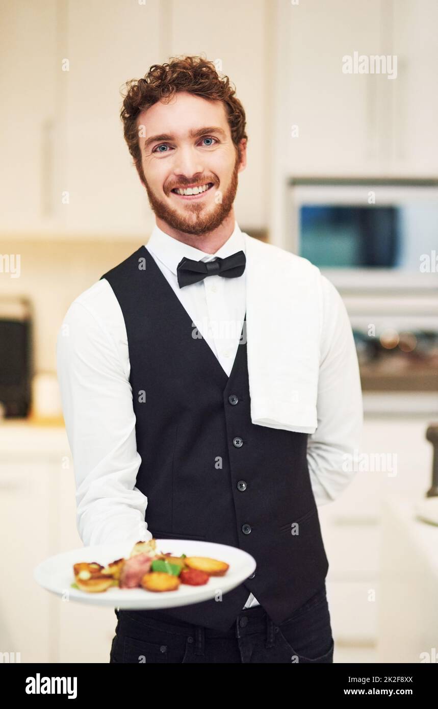This is tonights special. Cropped portrait of a handsome young waiter ...