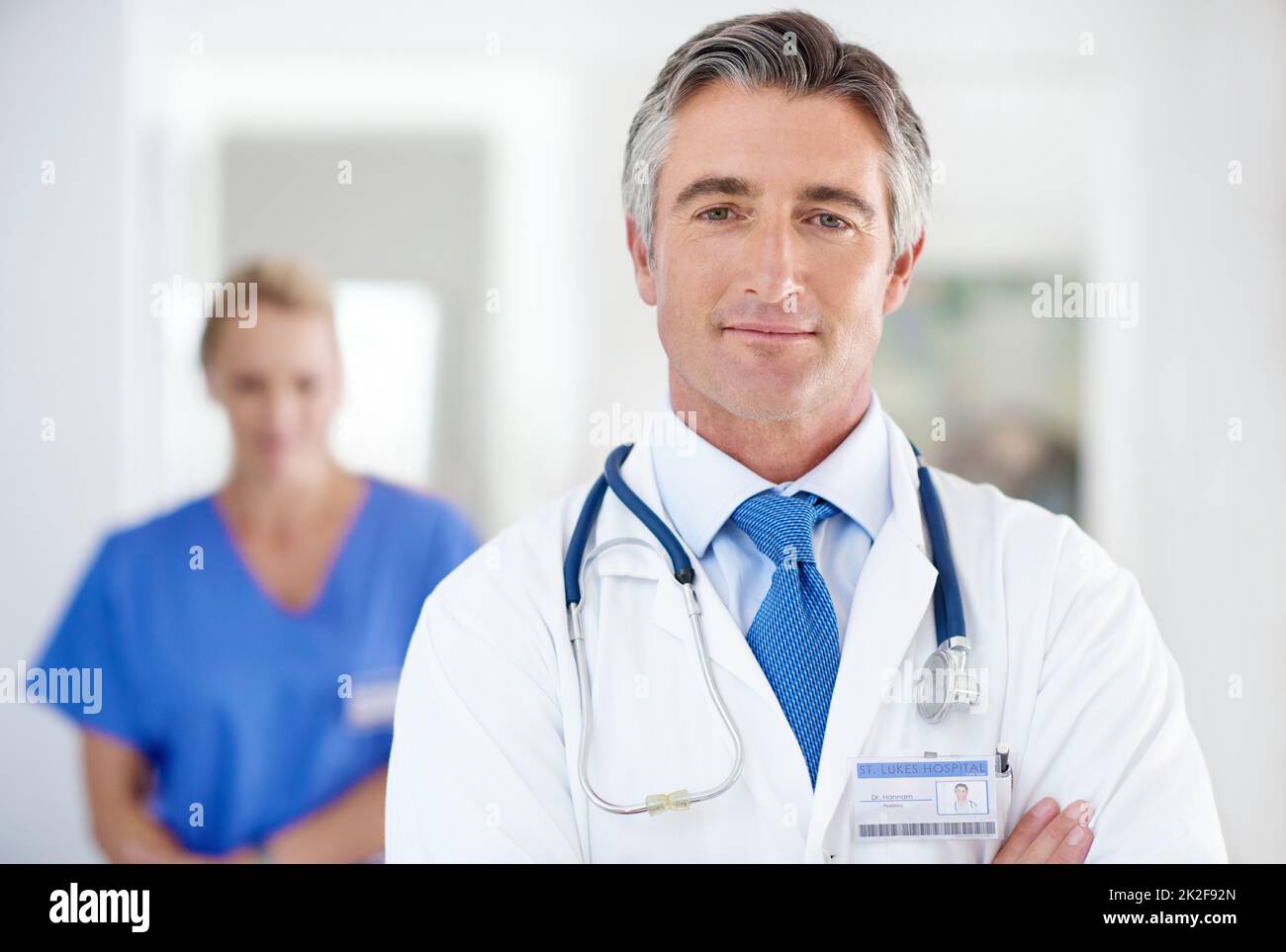 You come first. Portrait of a male doctor with a colleague standing in ...